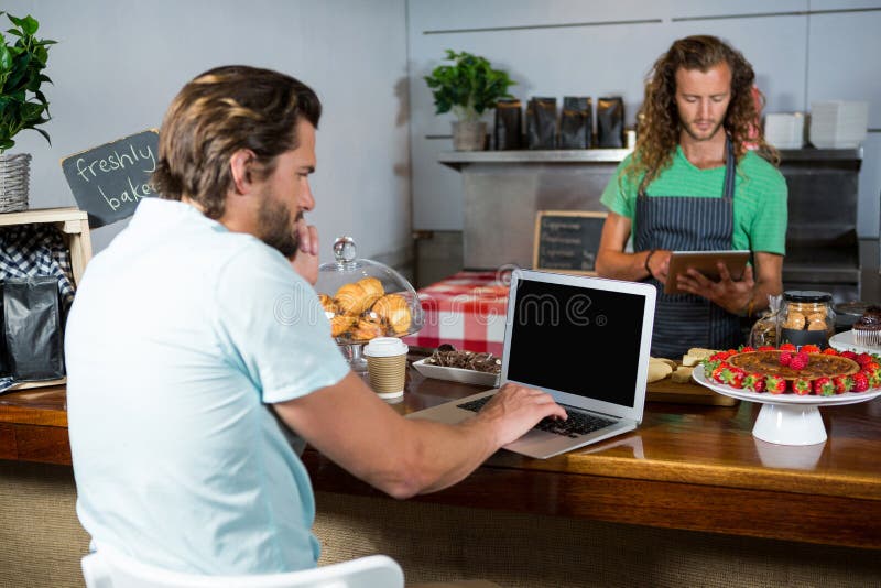 Customer and Staff Using Laptop and Digital Tablet at Counter Stock ...