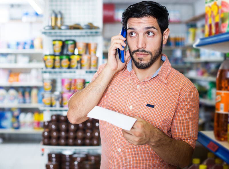Customer Standing with Note List and Talking Phone Stock Photo - Image ...