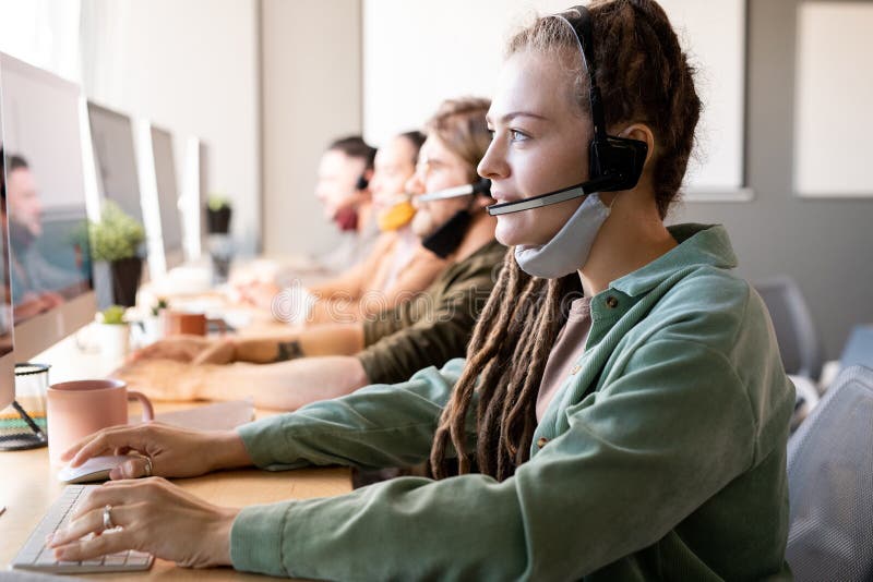 Customer Support Representatives with Headsets Looking at Computer ...