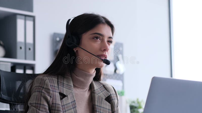 Customer Support Worker Communicates with Headset and Laptop in Office ...