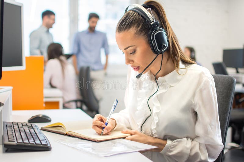 Customer Support Worker Taking Notes while Talking with Client Via ...