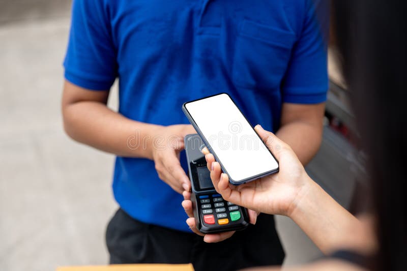 A Customer Tapping Her Smartphone on a Card Reader before Receiving a ...