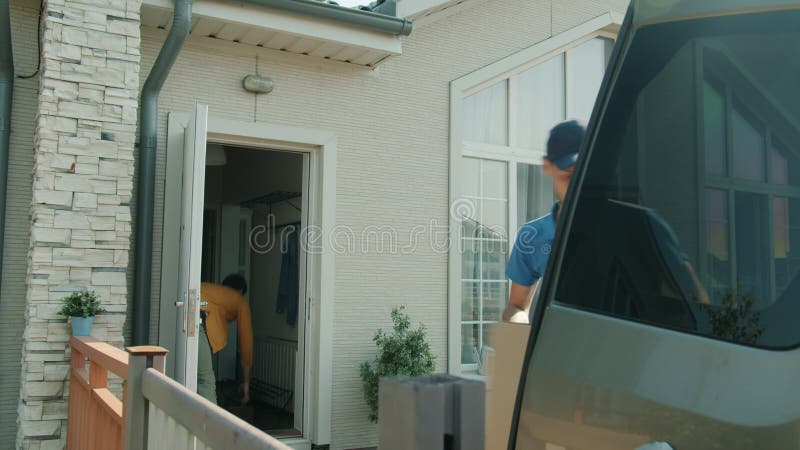 Customer Throwing Boxes Parcels To Delivery Worker Who is Loading ...