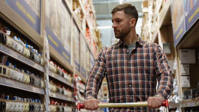 A Customer with a Trolley Walking in a Construction Store in the ...