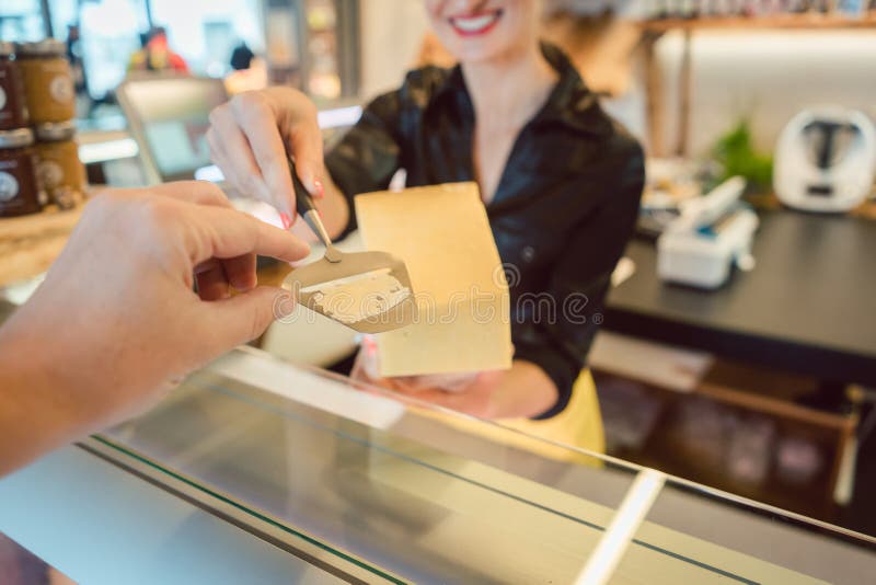 Customer Trying Bit of Cheese at the Deli Counter Stock Image - Image ...