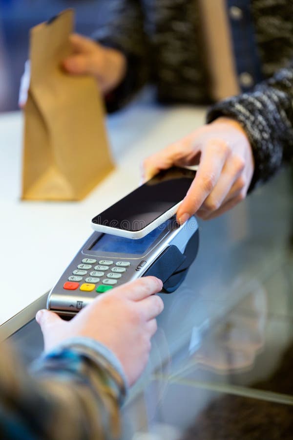 Customer Using Her Smartphone To Make Mobile Payment with Electronic ...