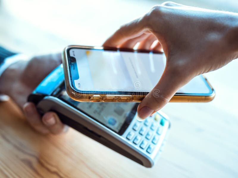 Customer Using Her Smartphone To Make Mobile Payment with Electronic ...