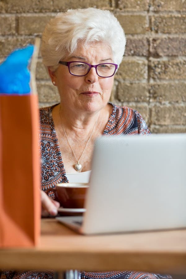 Customer Using Laptop in Cafe Stock Photo - Image of paperbag, drinking ...