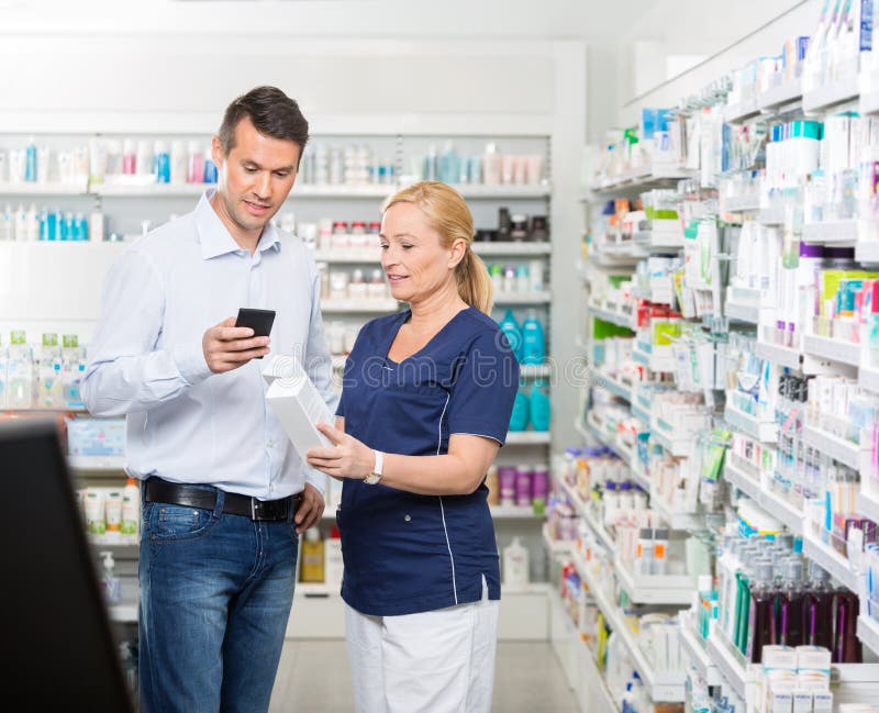 Customer Using Mobile Phone while Chemist Holding Stock Image - Image ...