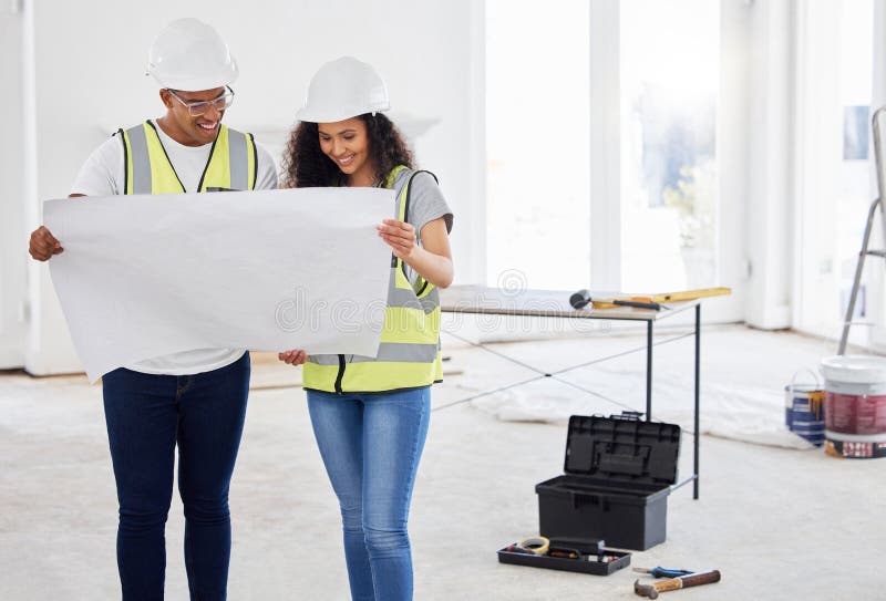 This is the Customers Plan. Two Young Contractors Standing Inside ...