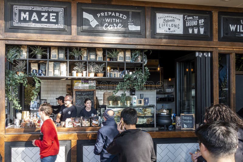 Customers Queue in Line To Receive Their Coffee Orders from the Maze ...