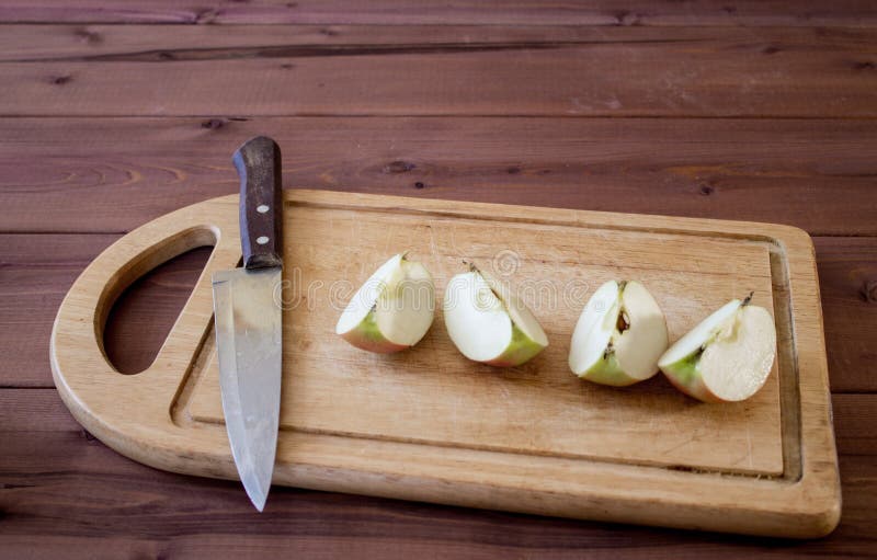 Cut Apples with a Kitchen Knife on a Cutting Board. Stock Photo - Image ...