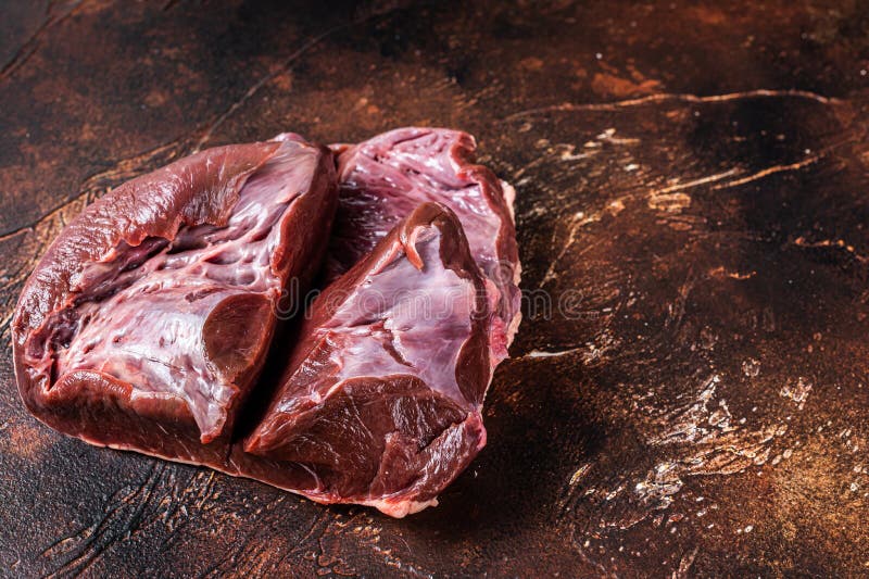 Cut Beef or Veal Raw Heart on a Butcher Table. Dark Background. Top ...