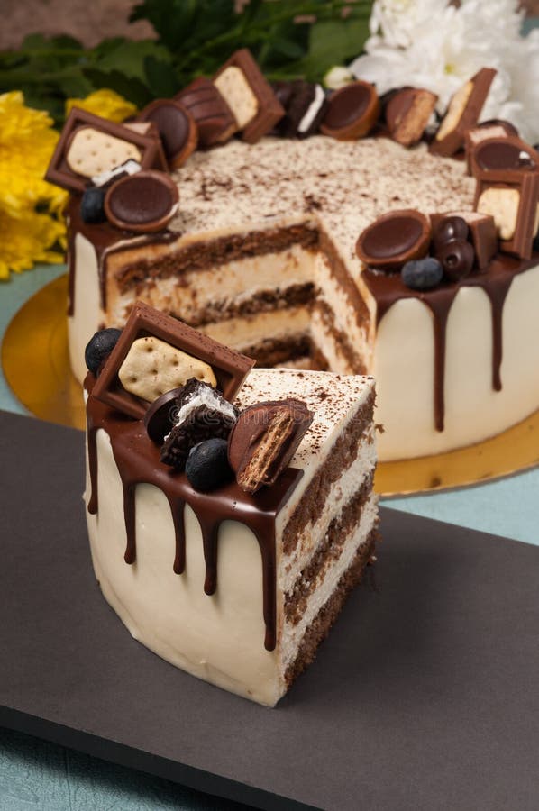 The Cut Cake is Decorated with Milk Chocolate Cubes and Berries Stock ...