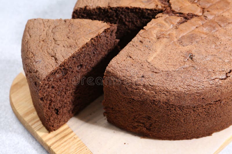 Cut Chocolate Sponge Cake on Light Table, Closeup Stock Photo - Image ...