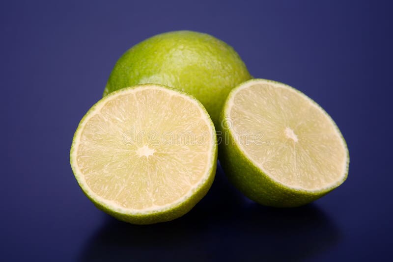 Cut Citrus Fruit of Green Lemon on Blue Background Stock Photo - Image ...