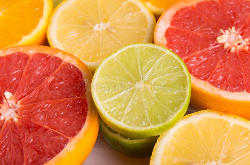 Cut Citrus Fruits on a Background of White Boards Stock Image - Image ...