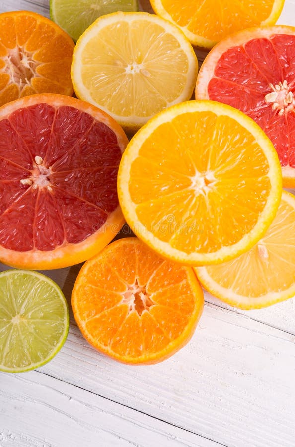 Cut Citrus Fruits on a Background of White Boards Stock Image - Image ...