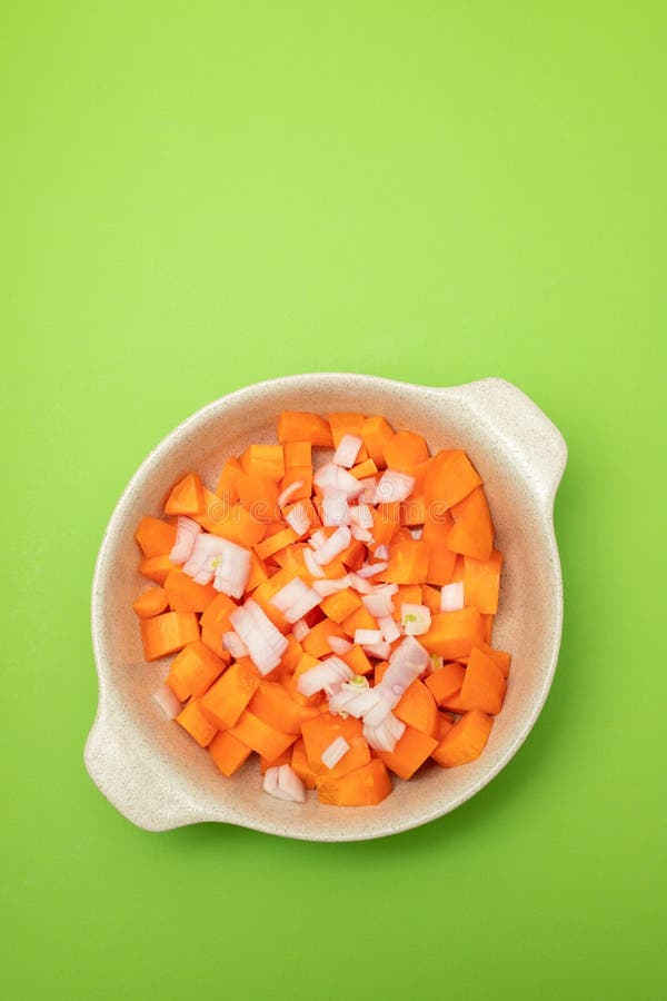 Cut Cubes of Fresh Carrot in the Bowl on Green Stock Photo - Image of ...