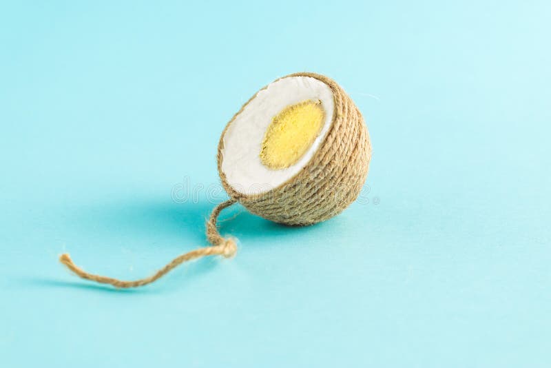 Cut Easter Egg with a Brown Rope on a Blue Background. Minimal Holiday ...