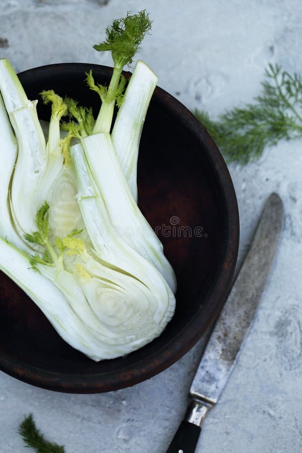 Cut fennel in an old bowl stock photo. Image of full - 91346110