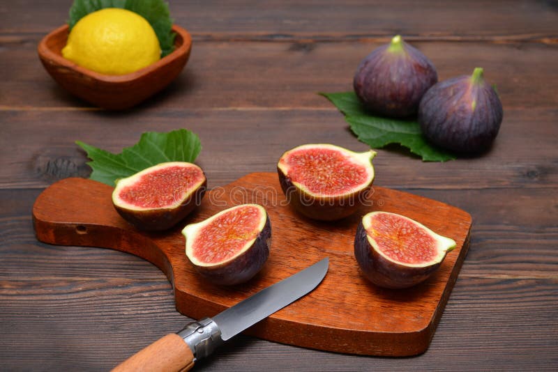 Cut Figs on a cutting Board on the table Stock Photo - Image of ...