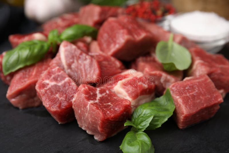 Cut Fresh Beef Meat and Basil Leaves on Slate Plate, Closeup Stock ...