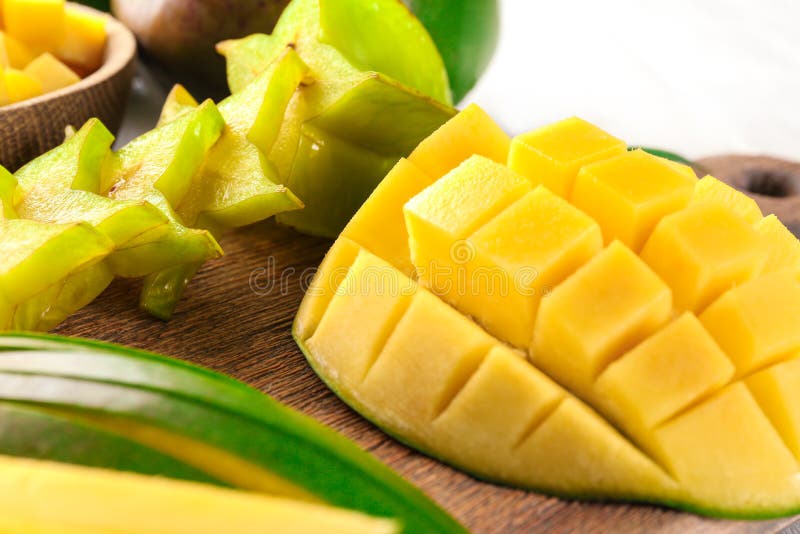 Cut Fresh Mango and Starfruit on Wooden Board, Closeup Stock Image ...