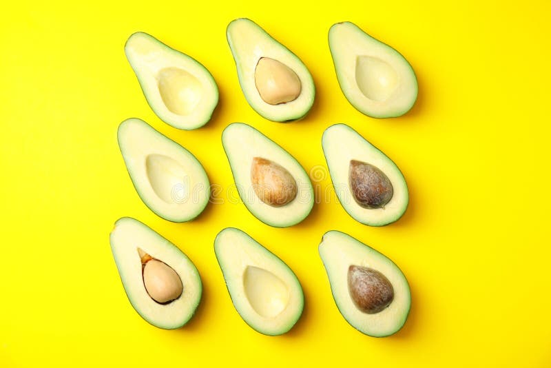 Cut Fresh Ripe Avocados on Yellow Background, Flat Stock Image - Image ...