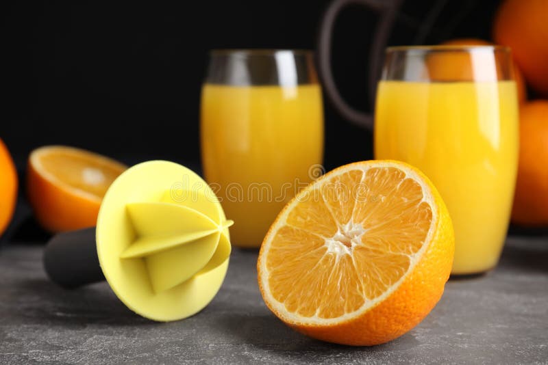 Cut Fresh Ripe Orange, Reamer and Juice on Grey Table, Closeup Stock ...