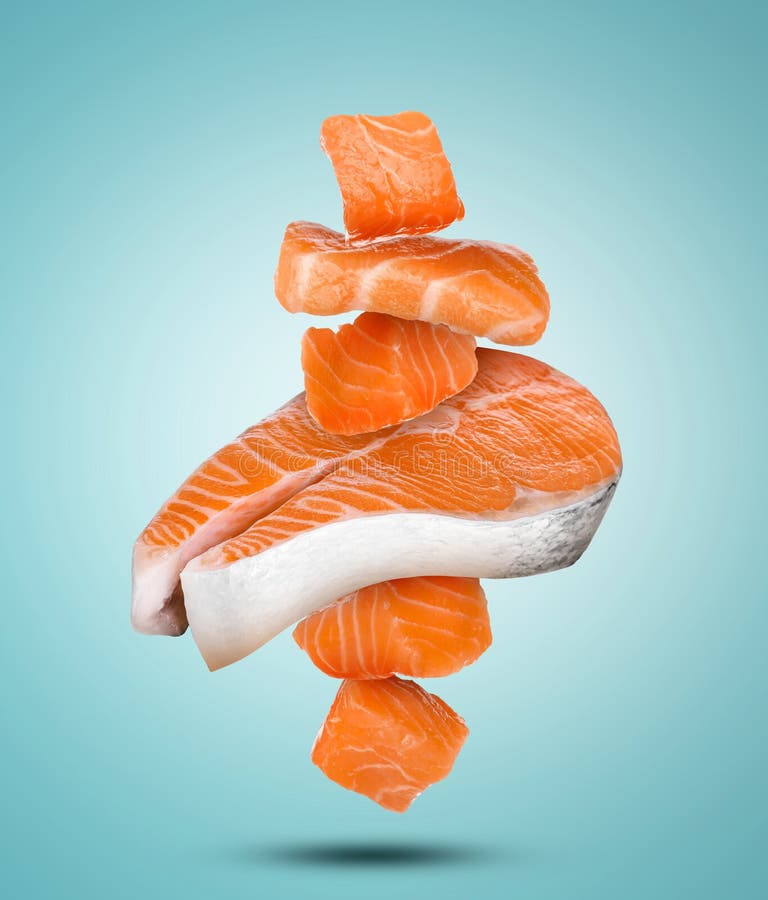 Cut Fresh Salmon Falling on Light Blue Background Stock Image - Image ...