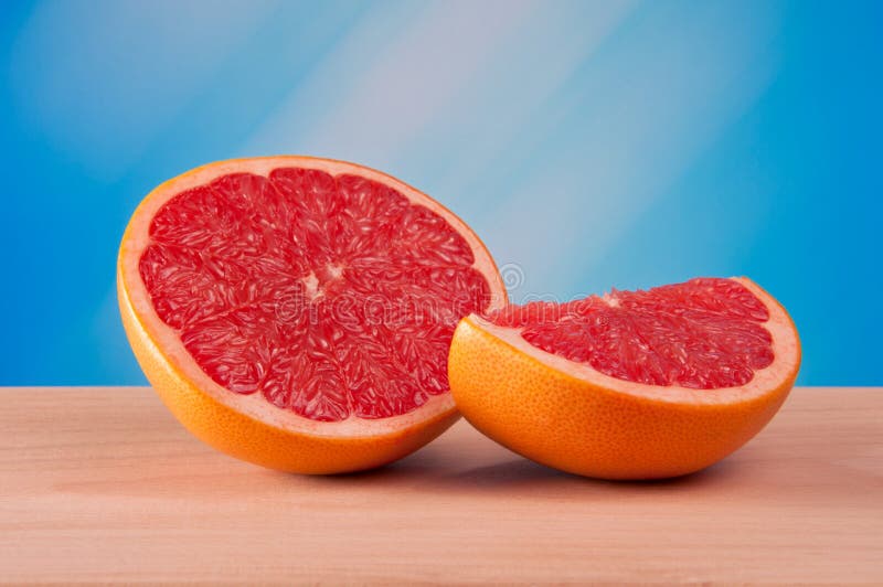 Cut Grapefruit on a Board with a Light Blue Background Stock Image ...