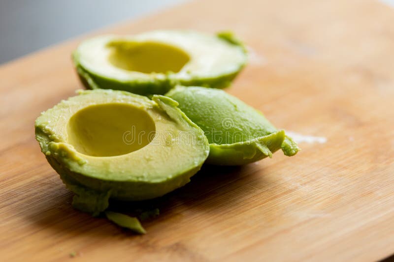Cut in Half Avocado Close Up on Wooden Board - Fresh and Nutrient-Rich ...