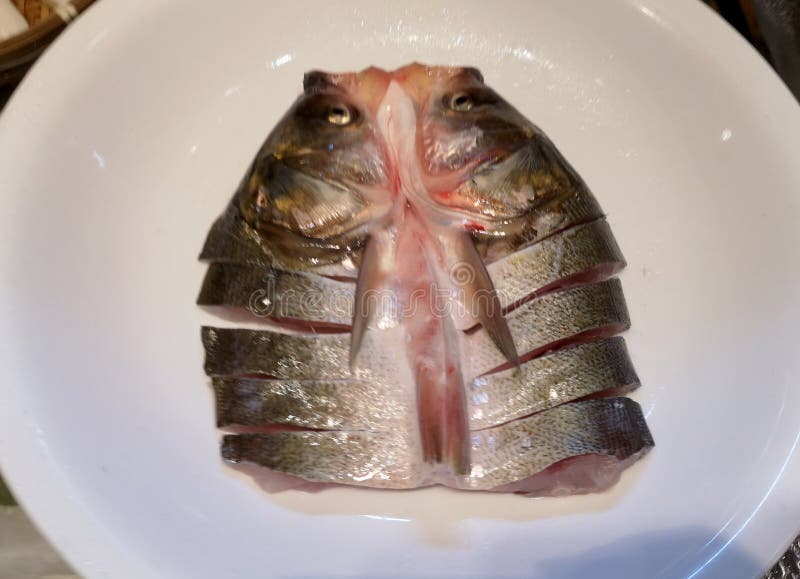 Cut in Half Fish Head on a Plate in the Restaurant Stock Photo - Image ...