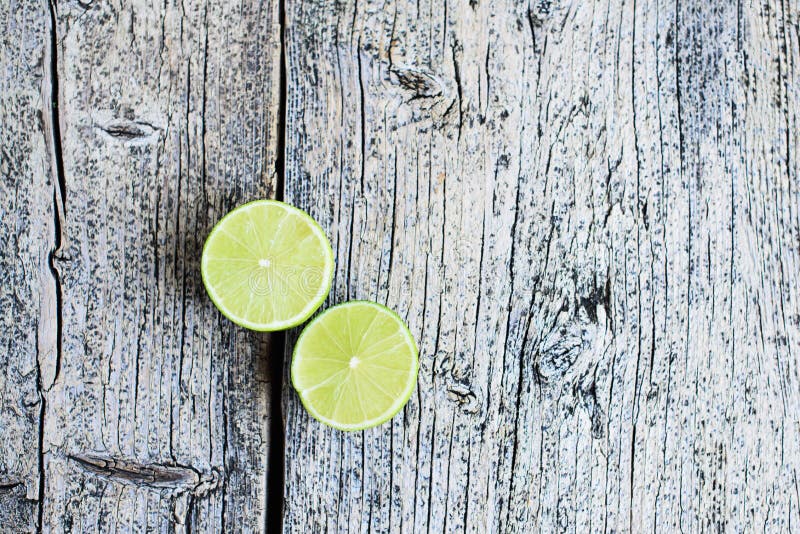 Cut on Halves of Lime is Lying on a Wooden Table Stock Photo - Image of ...