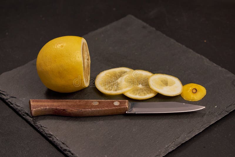 Cut Lemon Slices on Black Slate Stock Photo - Image of black, minimal ...