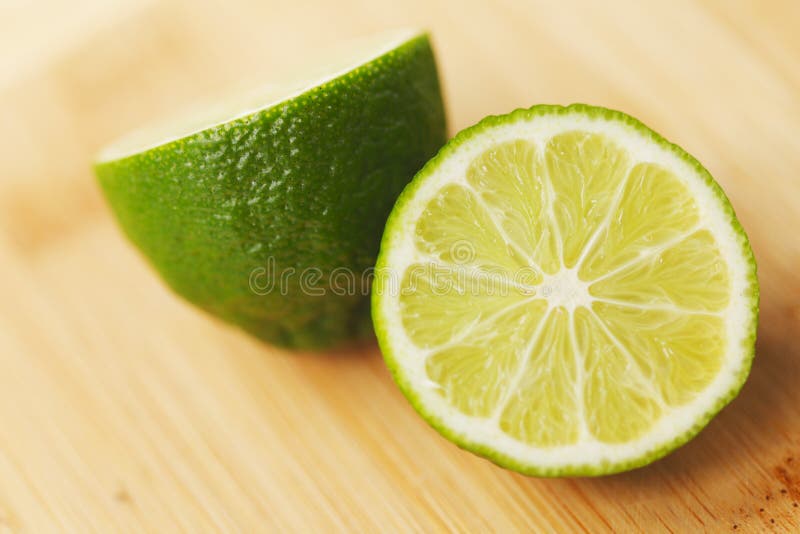 Cut lime on a wooden board stock photo. Image of board - 30021208