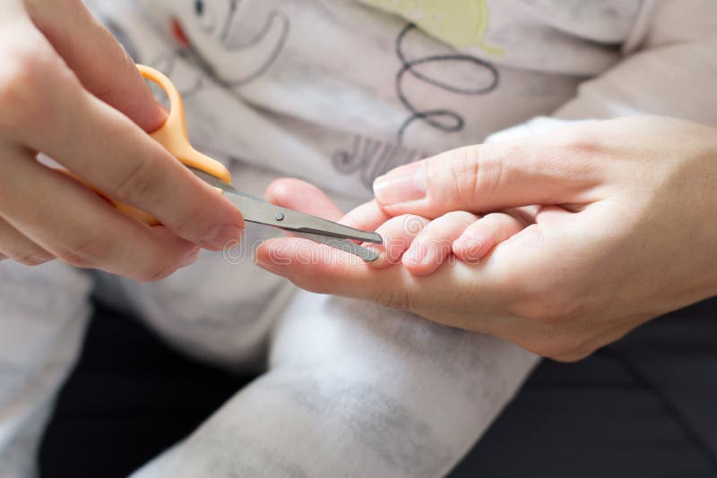 Cut off babys fingernails stock photo. Image of caregiver - 37948826