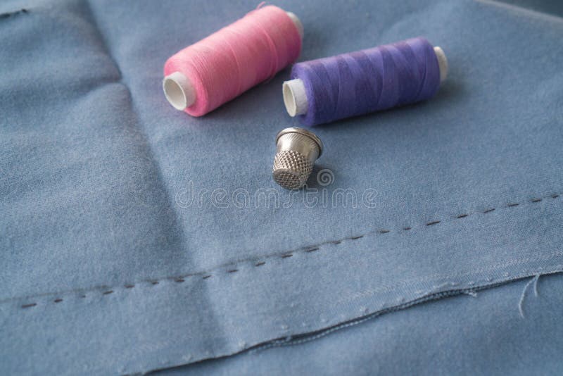 Cut Part of Skirt with a Sewn Tuck, Thimble and Two Spools of Thread ...