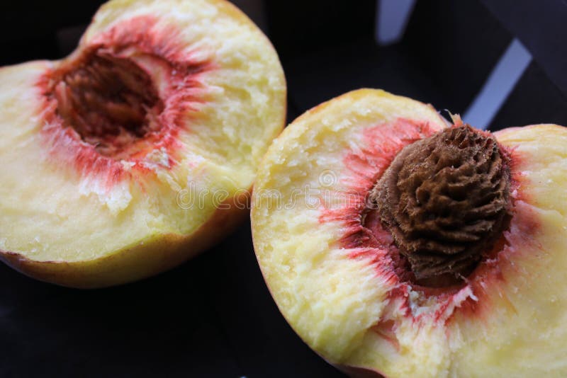 Cut peach into two parts stock photo. Image of fruit - 165256018