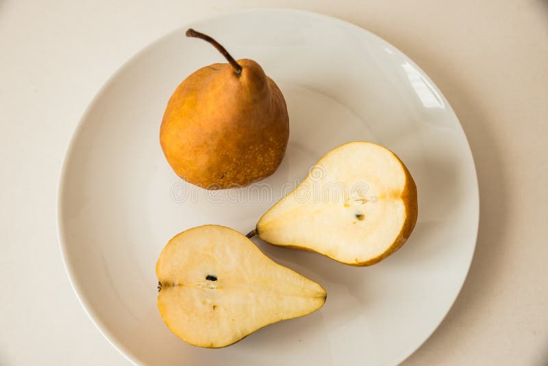 Cut pears on a white plate stock photo. Image of agriculture - 170576726