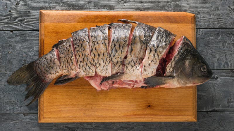 Cut into Pieces Carp Fish with on a Black Table. the View from the Top ...