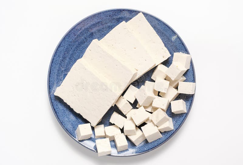 Cut into Pieces and Cubes of Tofu on a Blue Plate Close-up on White ...