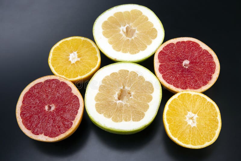Cut Pieces of Different Citrus Fruits on Dark Background Stock Photo ...