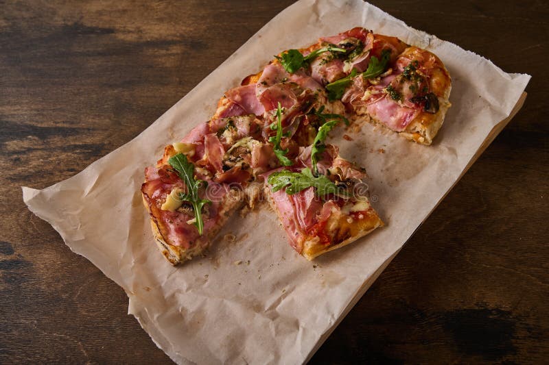 Cut into Pieces Rectangular Roman Pizza with Prosciutto Ham, Tomatoes ...
