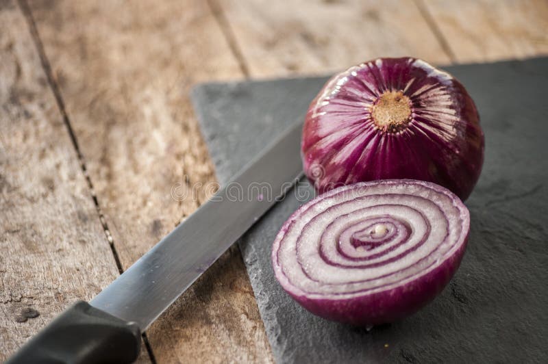 Cut red onion stock image. Image of hand, root, food - 73896889