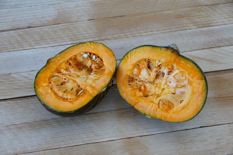 Cut Small Round Pumpkin on Wooden Background Stock Image - Image of ...