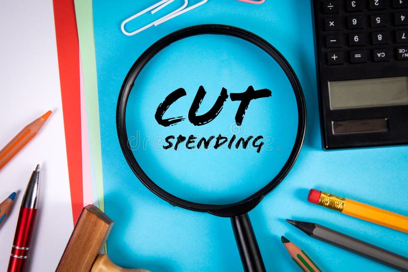 Cut Spending Concept. Magnifying Glass on Office Desk Stock Photo ...