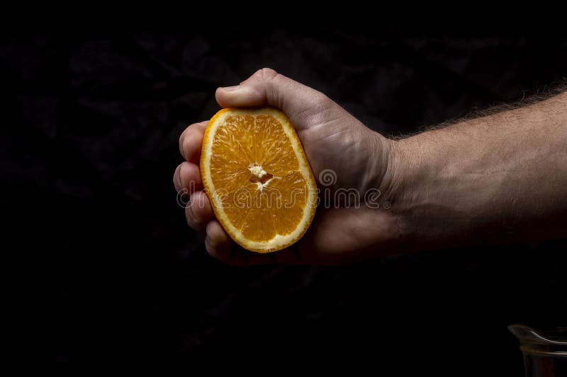 Cut Squeezed Orange in Hand Stock Photo - Image of finger, natural ...