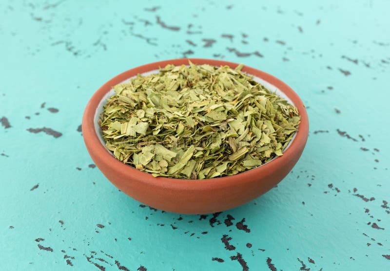 Cut Tarragon in a Small Terracotta Bowl on a Mottled Tabletop Side View ...